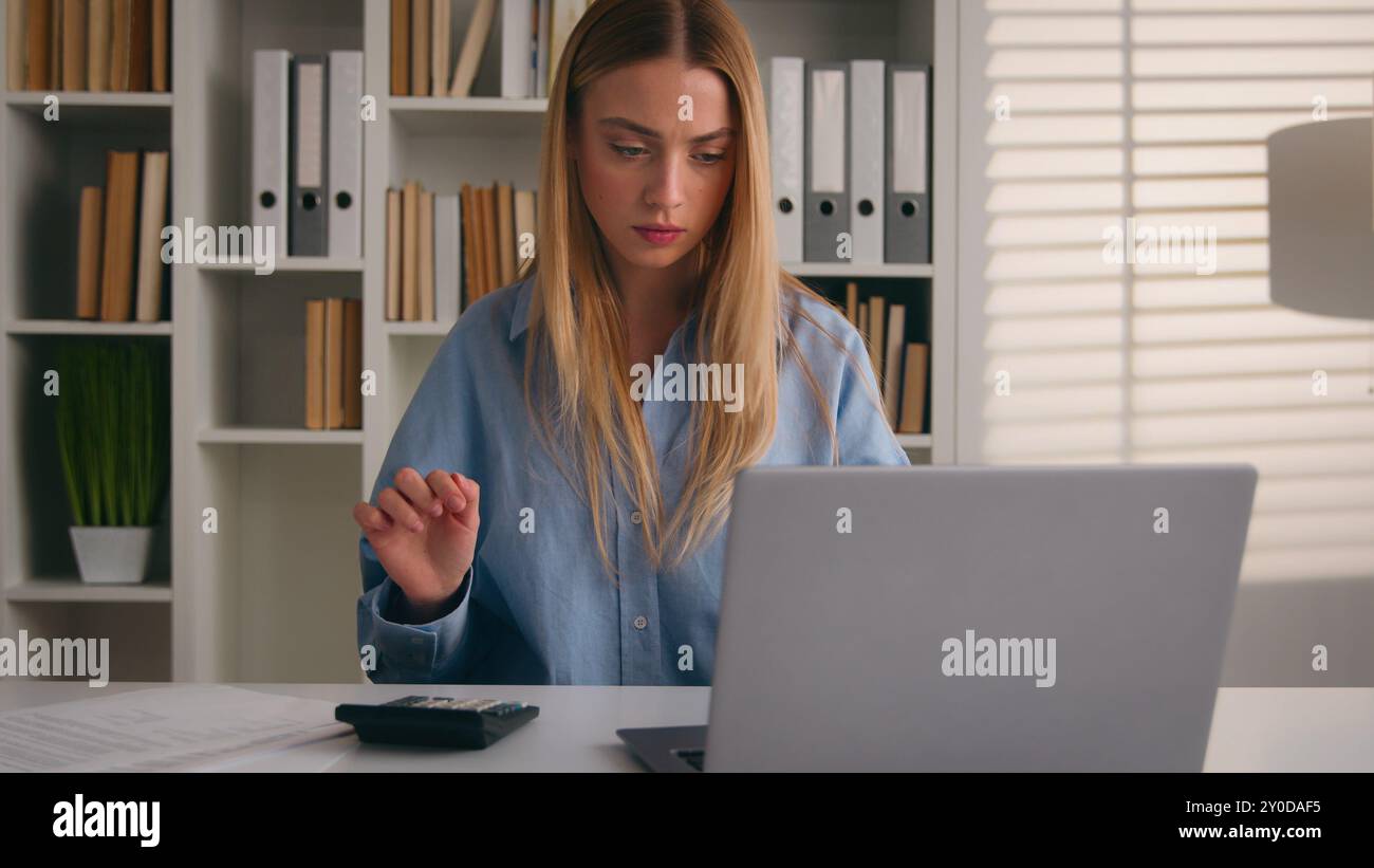 Confused puzzled Caucasian girl woman at office counting money business ...