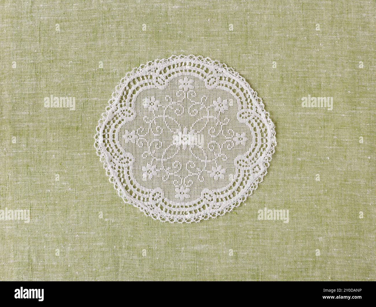 Doily and green linen cloth Stock Photo - Alamy