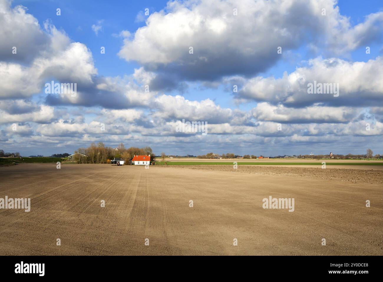 Beautiful sky over dutch farmhouse and big plowed field Stock Photo - Alamy