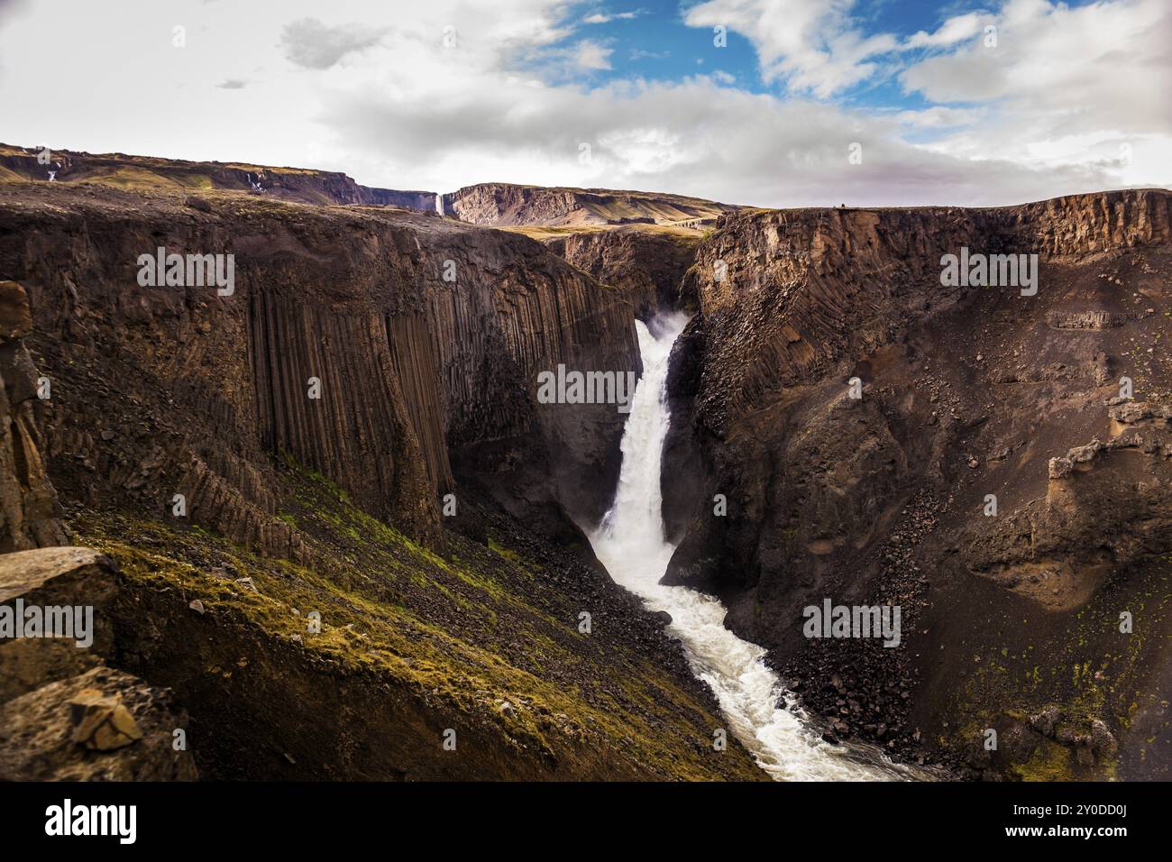 Waterfall gushing through volcanic rock on Iceland Stock Photo - Alamy