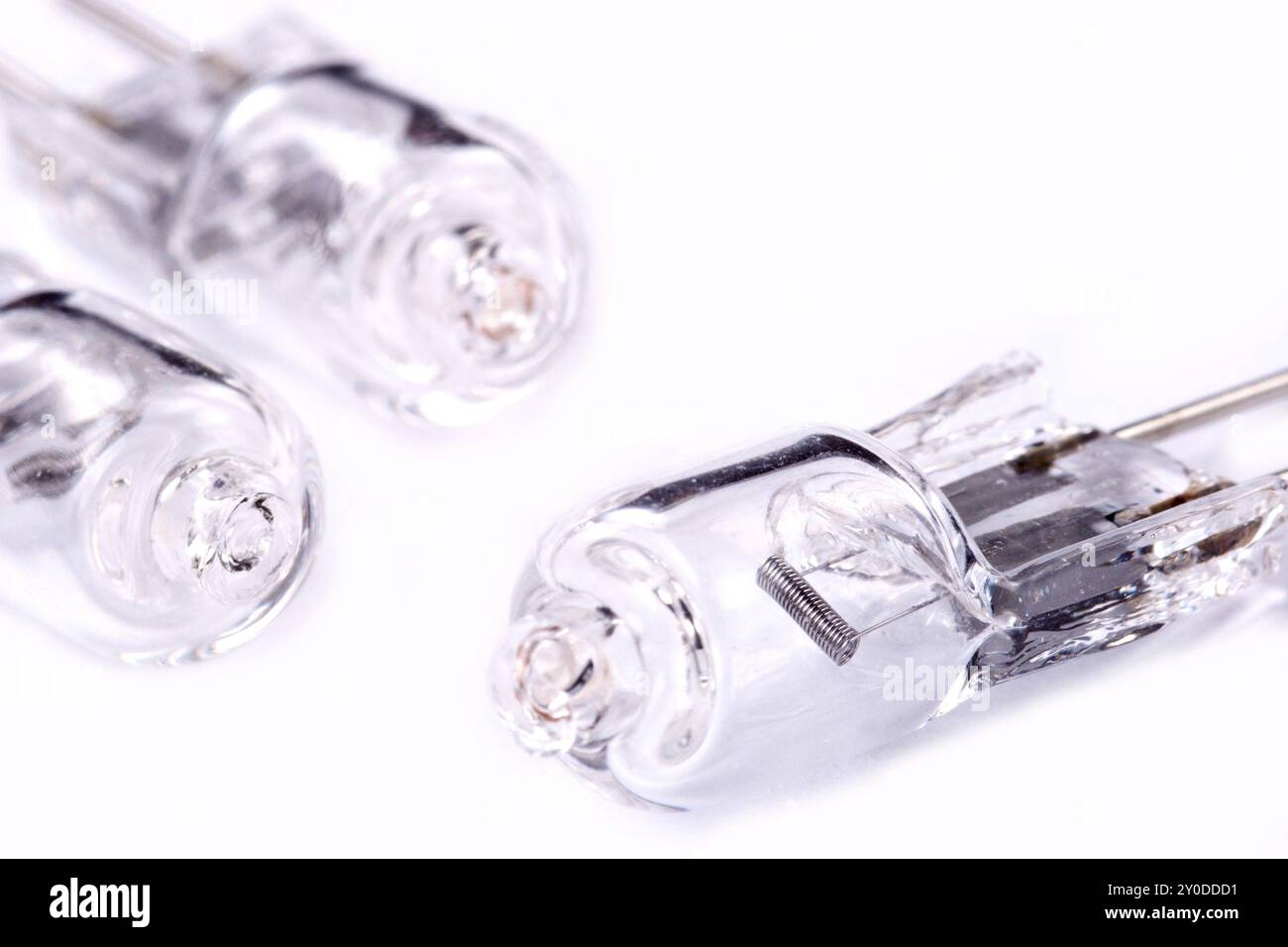 Three halogen lamps on a light grey background Stock Photo - Alamy