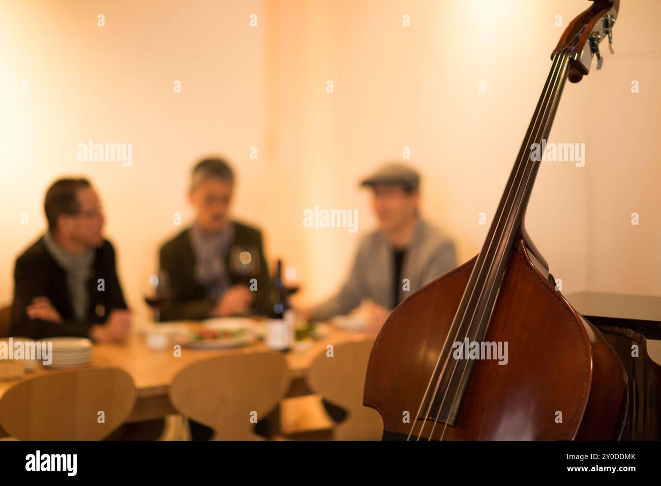 Elderly men giving a toast at a restaurant and musical instruments ...
