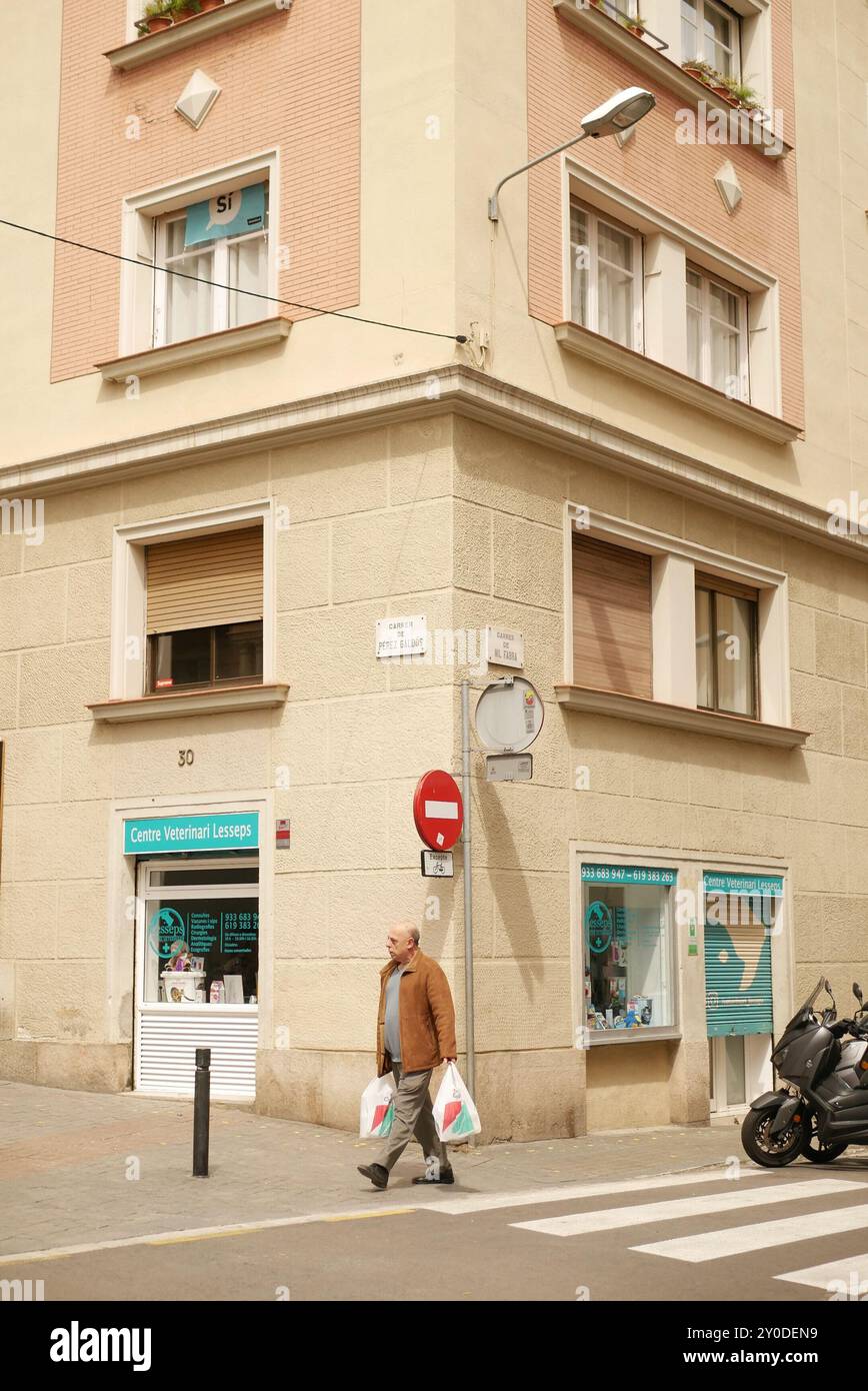 A candid pedestrian man walking with shopping bags at a corner ...