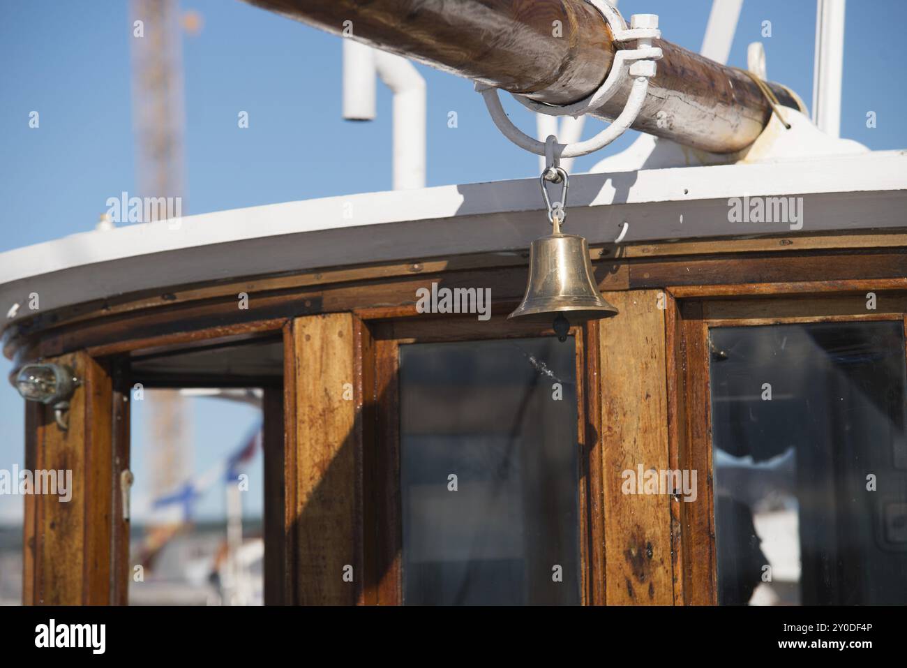 Bell hanging from the boom by the wheel house of a wooden ship Stock ...