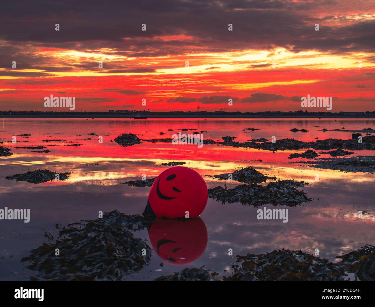 Smiley buoy with red sky sunset reflections at Sutton Strand Stock ...