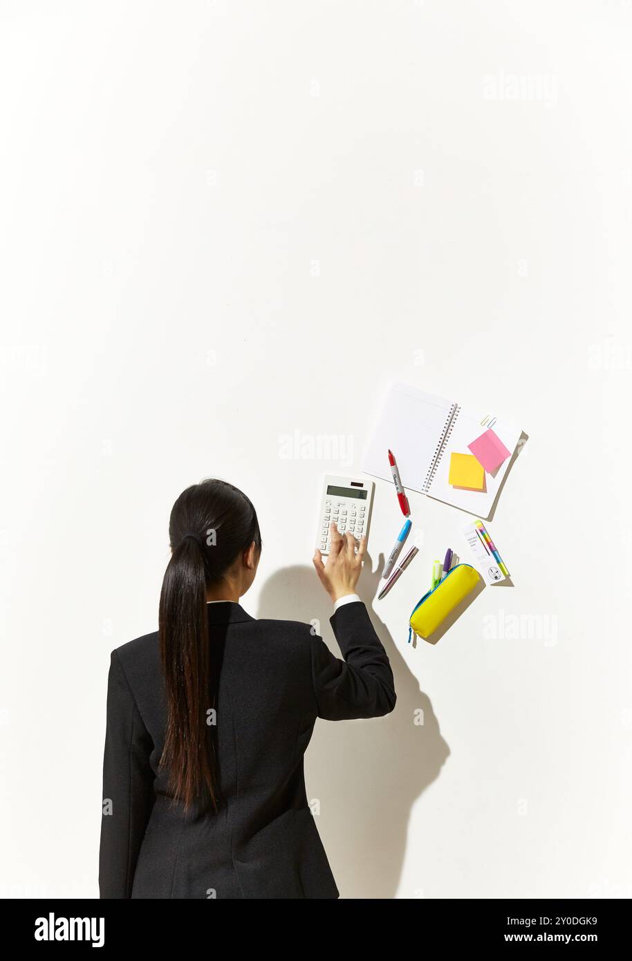 Businesswoman tapping a calculator Stock Photo - Alamy