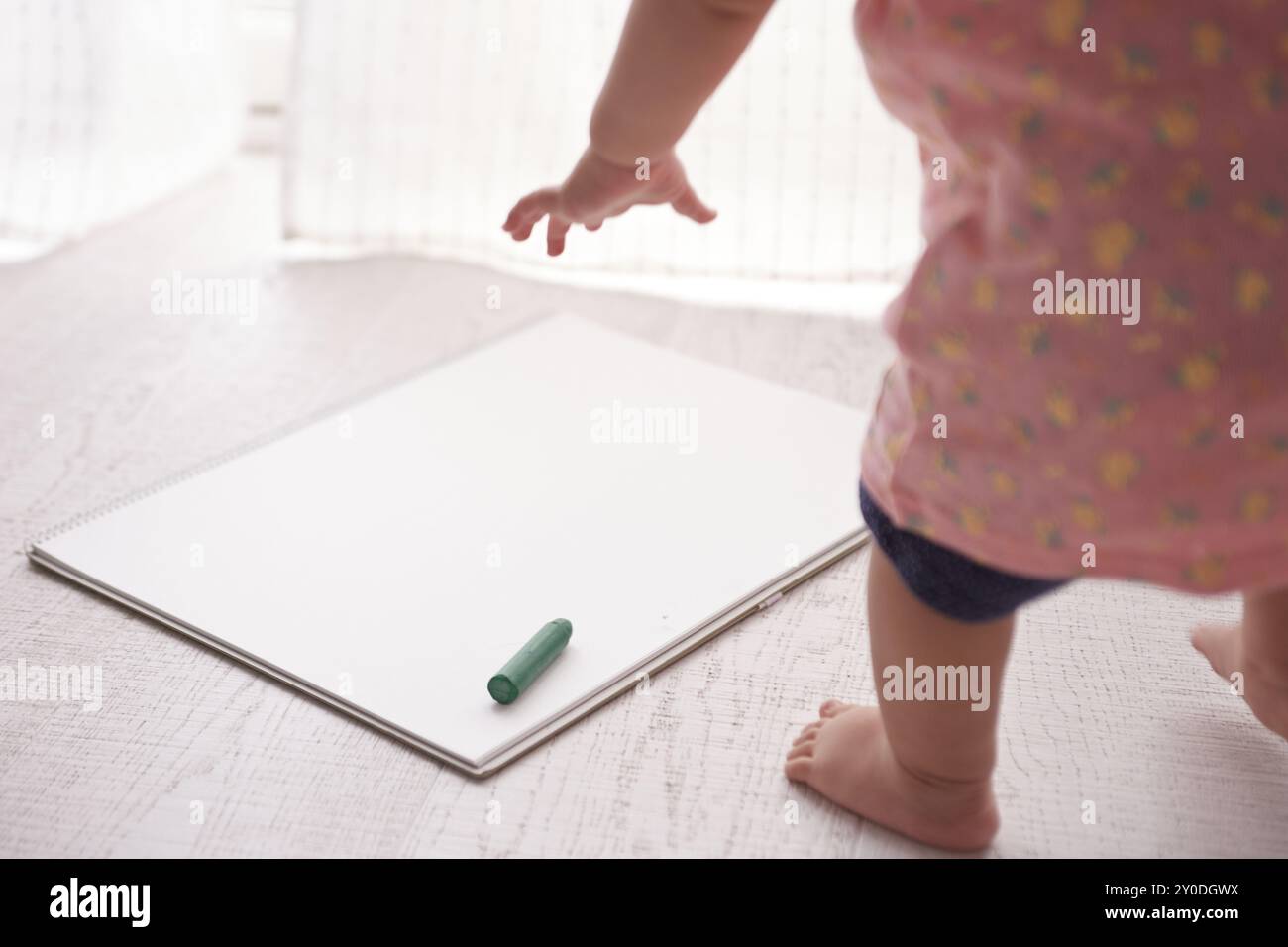 Baby trying to draw on a sketchbook Stock Photo - Alamy