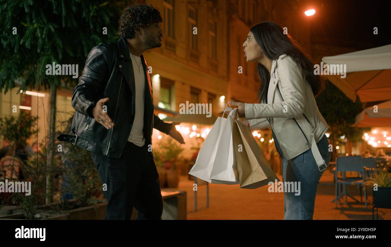Ethnic Arabian Indian angry aggressive couple with shopping bags ...