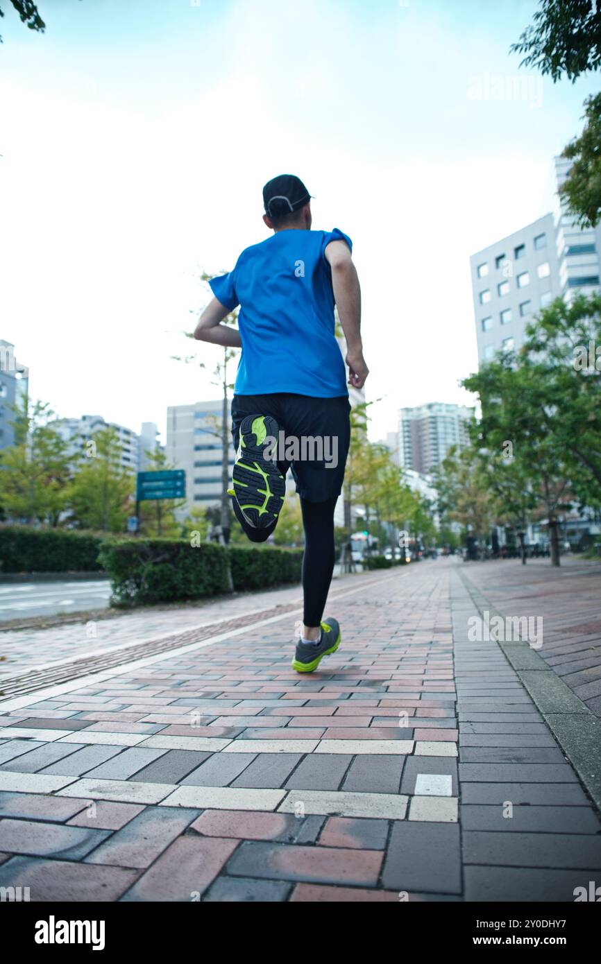 Back figure of running man Stock Photo - Alamy