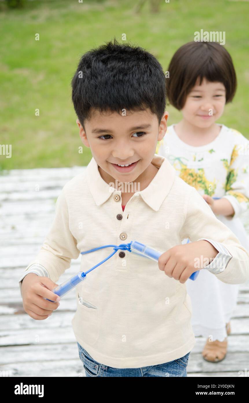 Children playing with train games with jump rope Stock Photo - Alamy