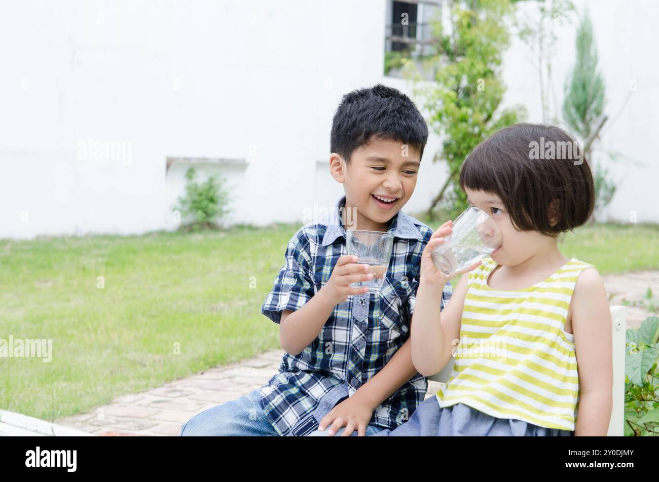 Children laughing while drinking water Stock Photo - Alamy