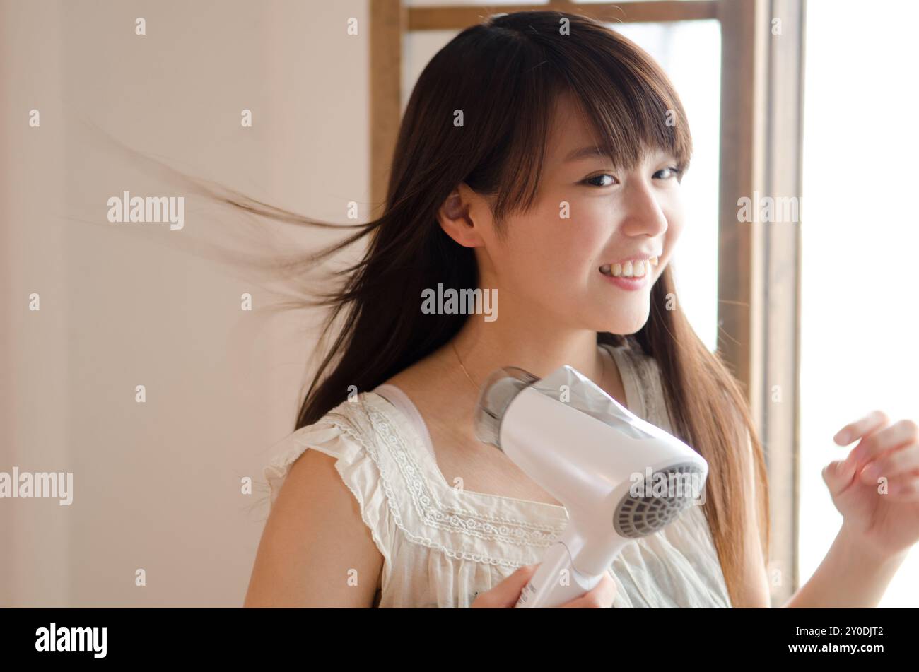 Woman using dryer hi-res stock photography and images - Alamy