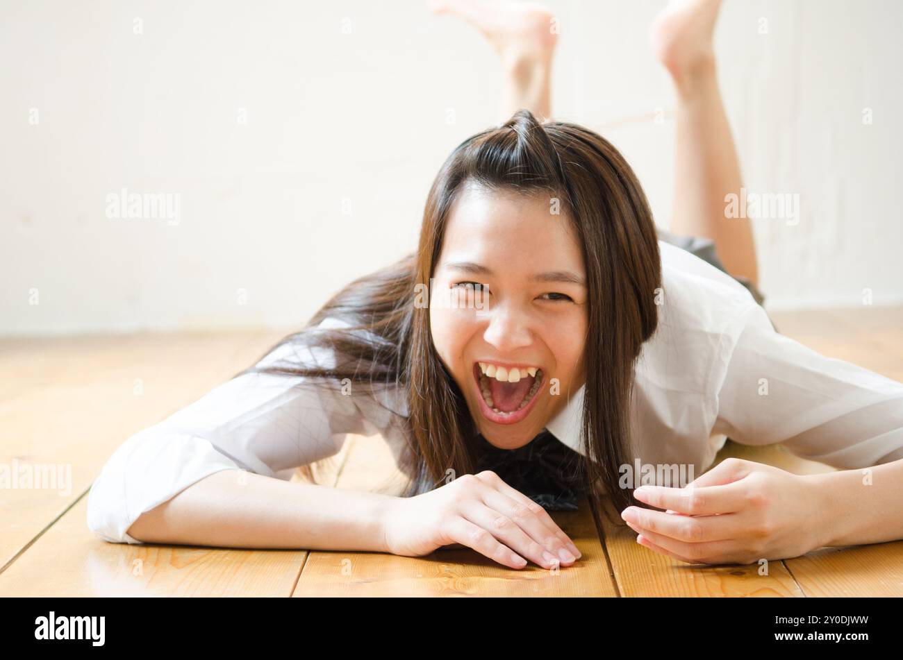 A woman in her uniform was lying on the floor and laughing loud Stock Photo - Alamy