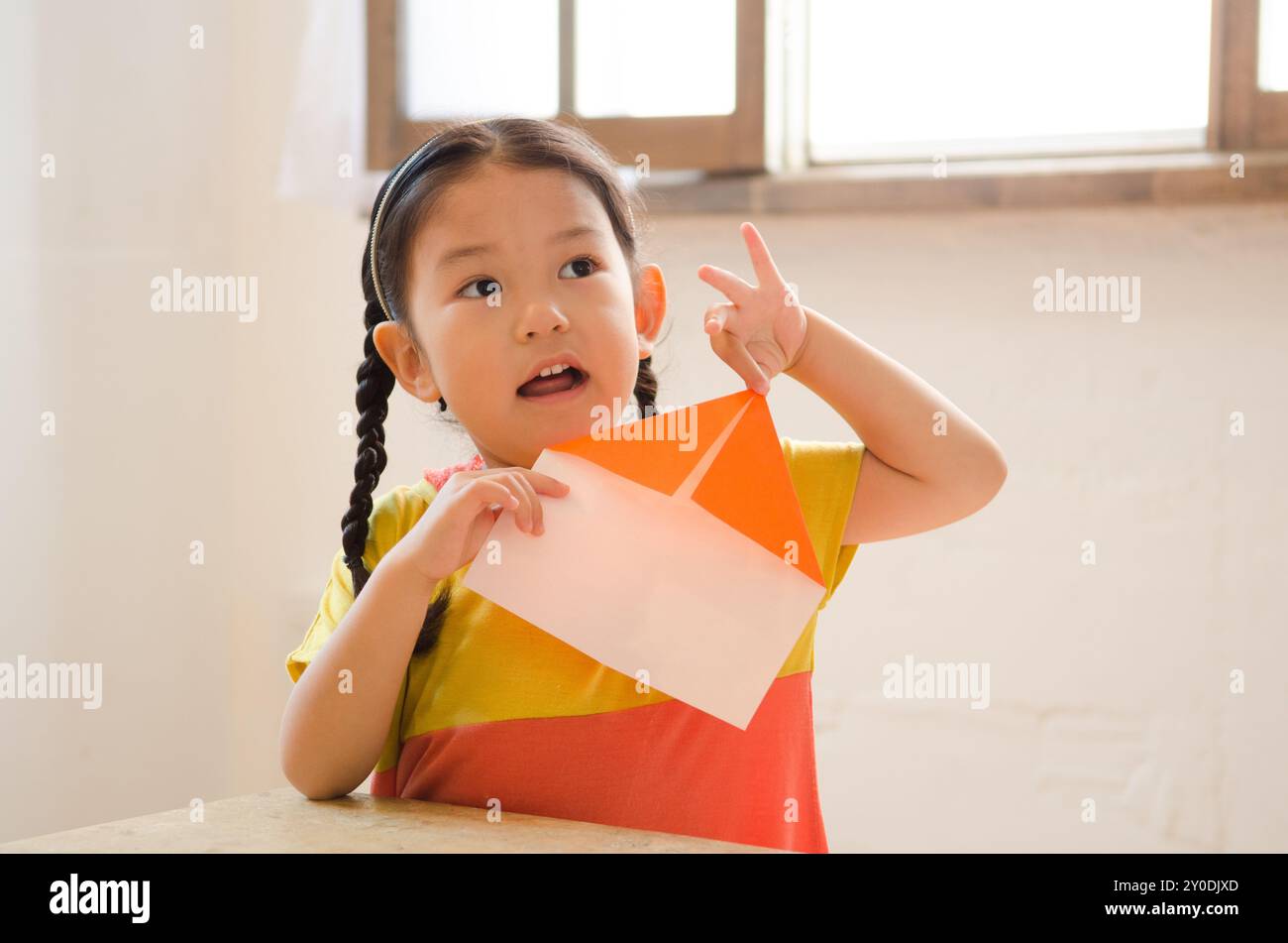 A girl cutting paper Stock Photo - Alamy