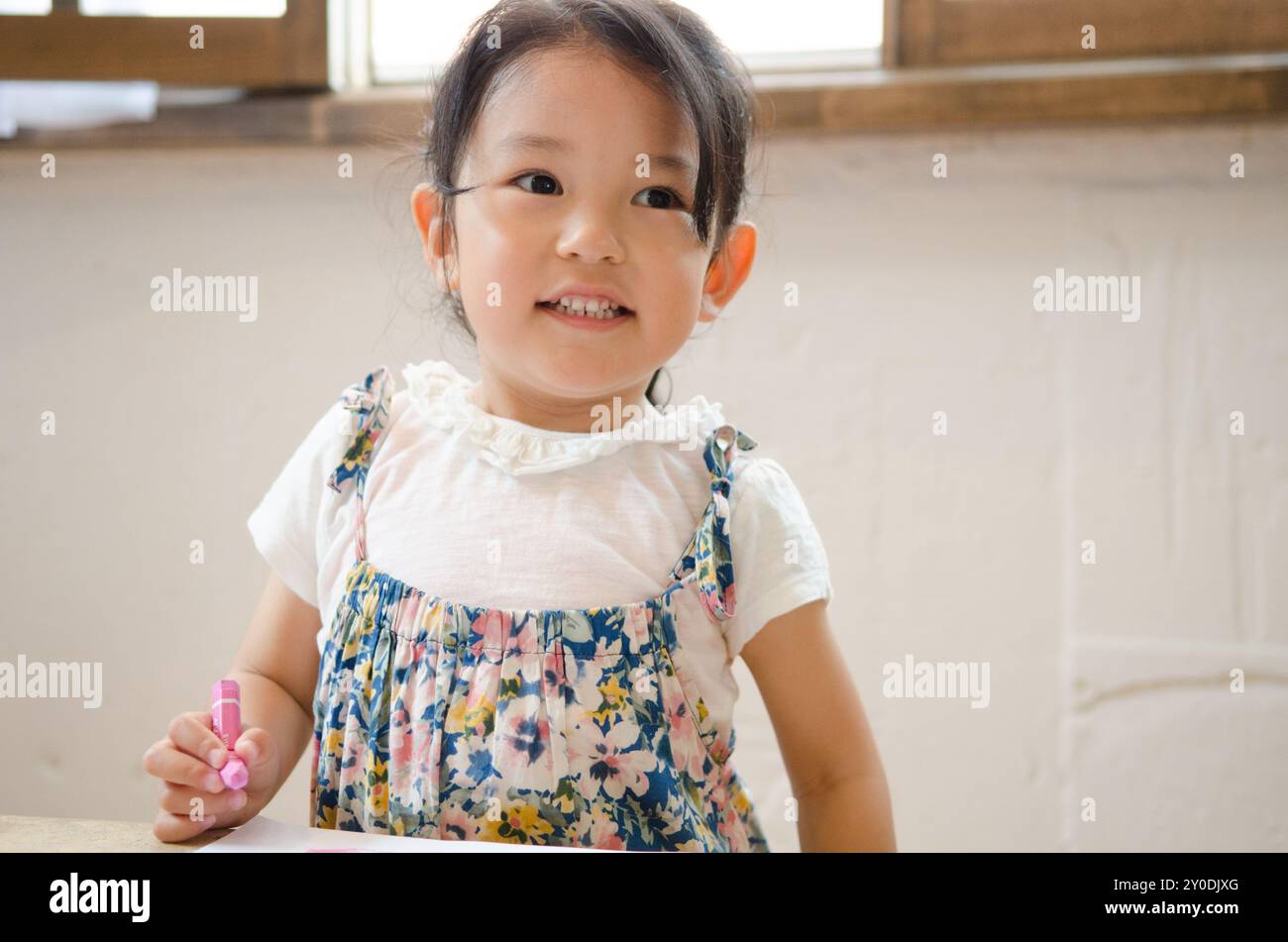 A smiling girl inside a room Stock Photo - Alamy