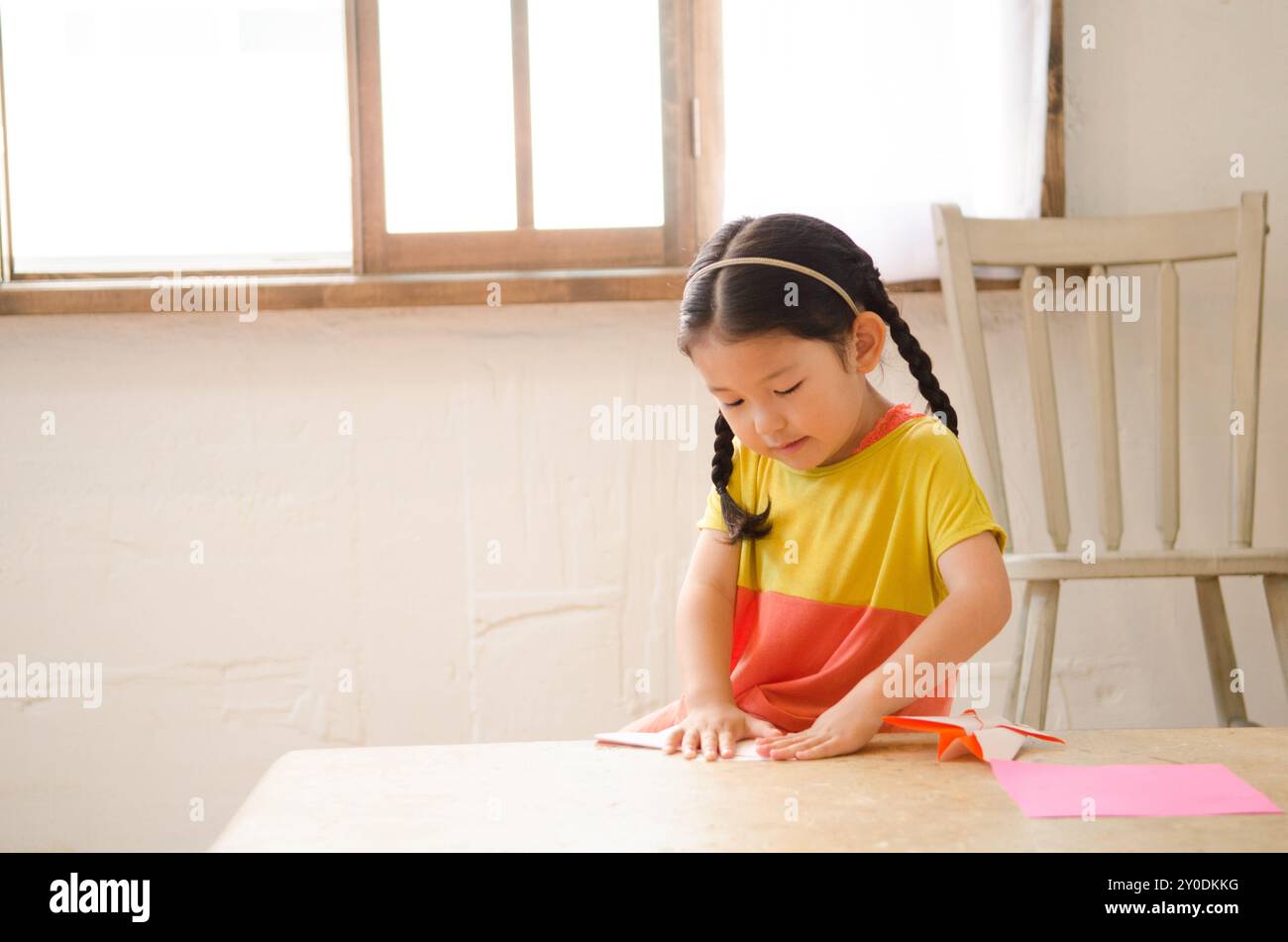 A girl cutting paper Stock Photo - Alamy