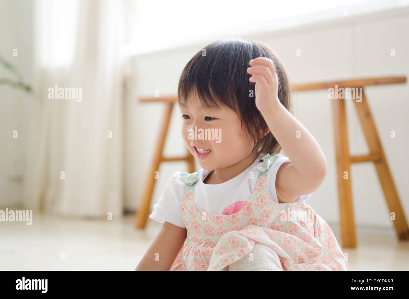 A girl raising her hand Stock Photo - Alamy