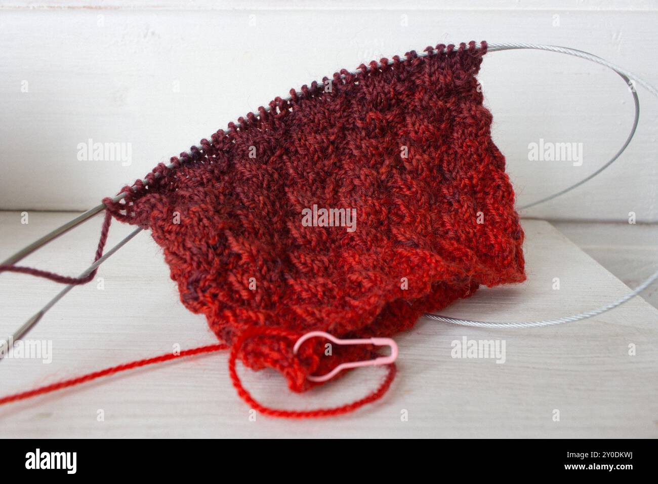 Bright colourful yarn ball with knitted crochet and needles. Bright ...