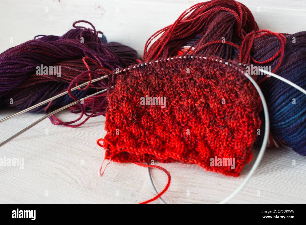 Bright colourful yarn ball with knitted crochet and needles. Bright ...