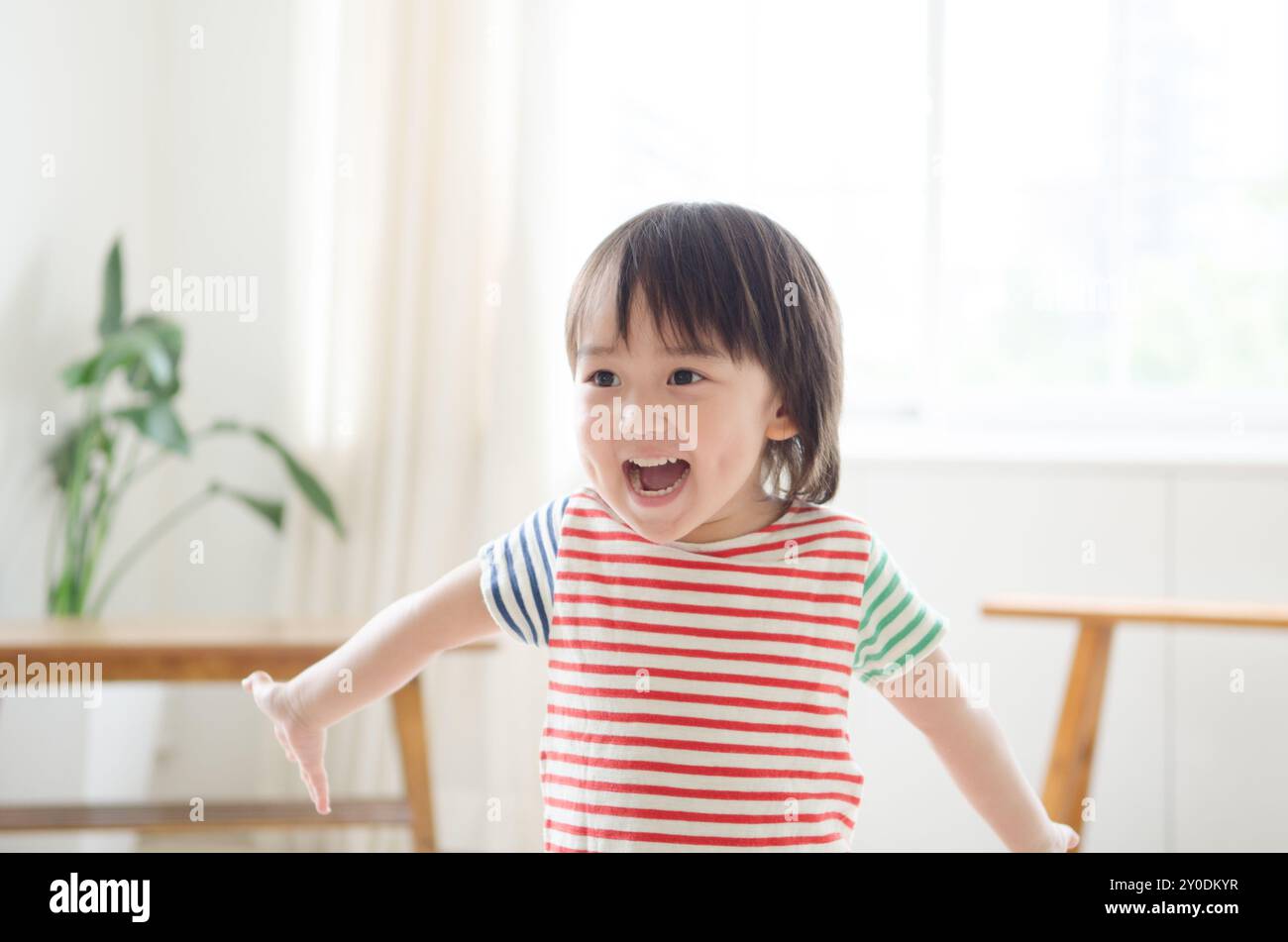 A boy laughing with open arms Stock Photo - Alamy