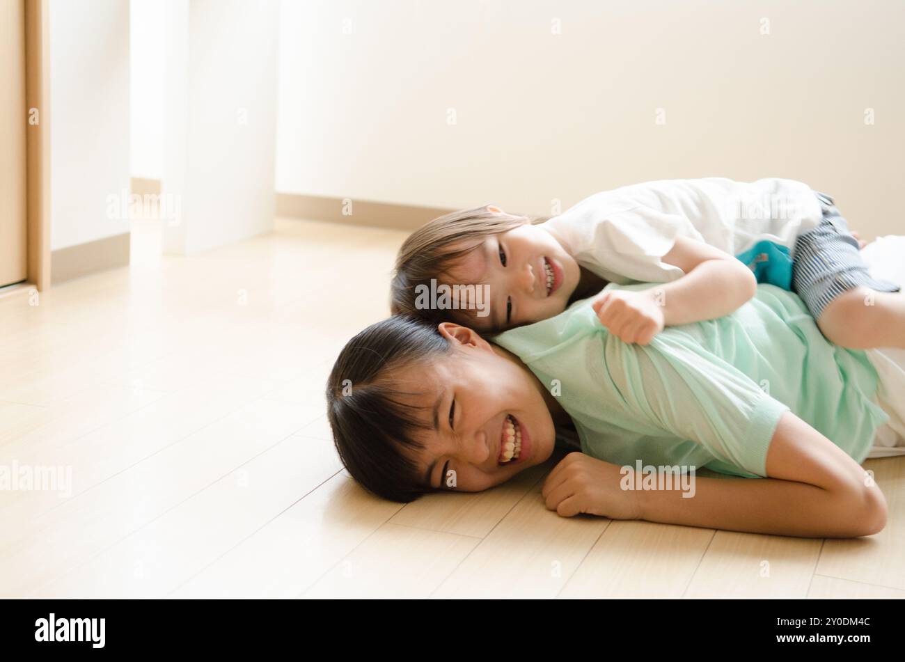 Children are rolling on the floor and laughing Stock Photo - Alamy