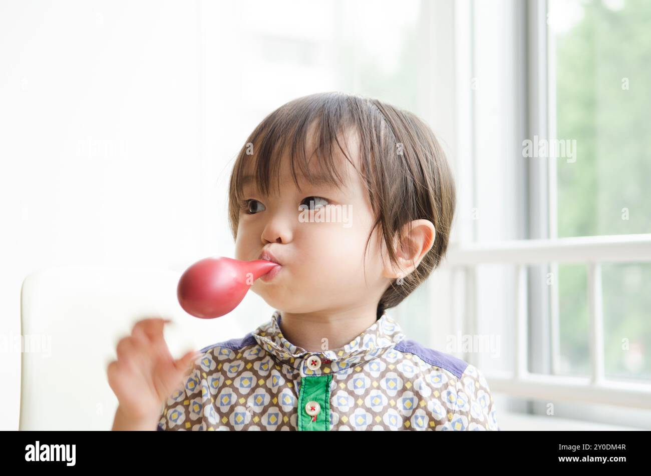 Cute boy blow up balloon hi-res stock photography and images - Alamy