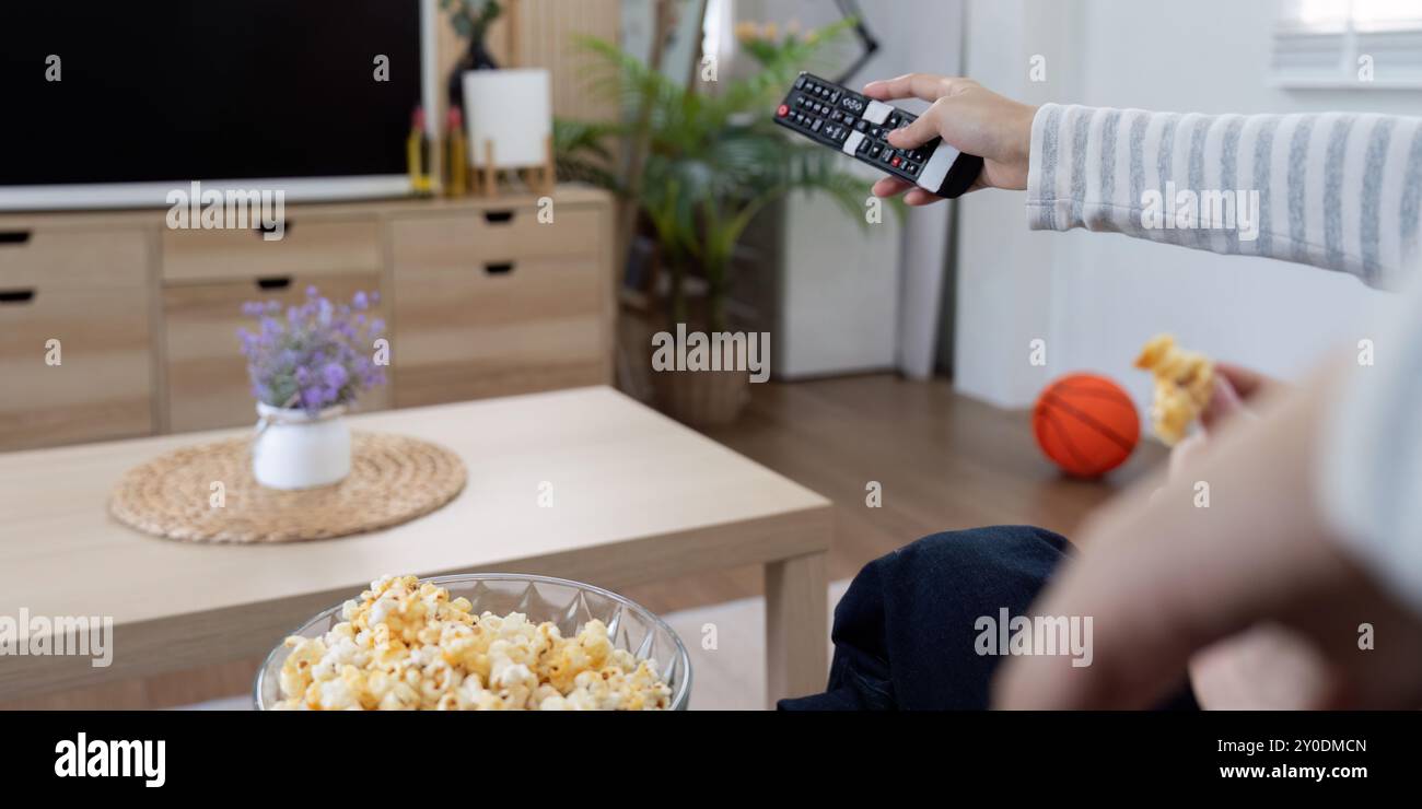 Relaxing home movie night with popcorn and remote Stock Photo - Alamy