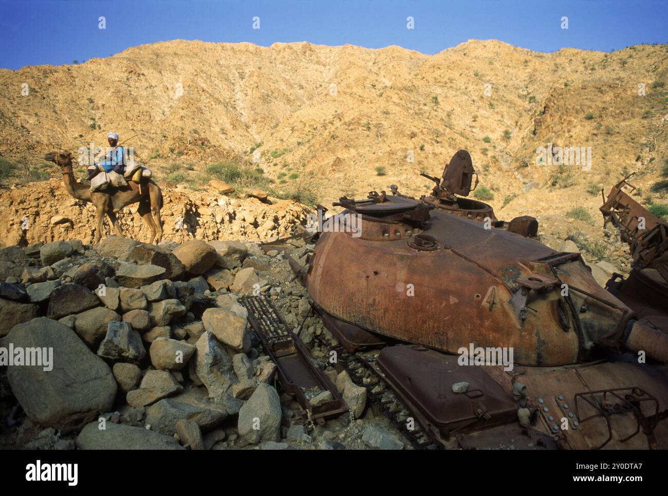 Man rides a camel past a ruined Ethiopian army tank Stock Photo - Alamy