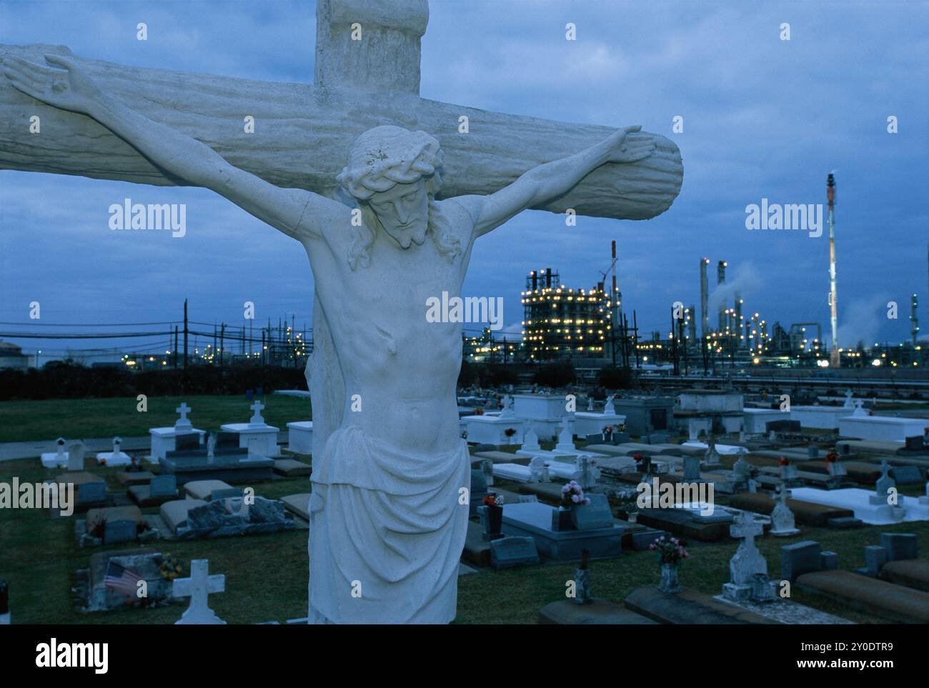 Statue of Jesus and raised graves in a cemetery in Taft, Louisiana ...