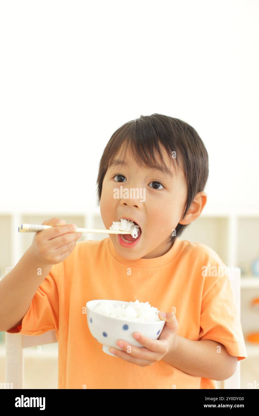 Boy eating rice Stock Photo - Alamy
