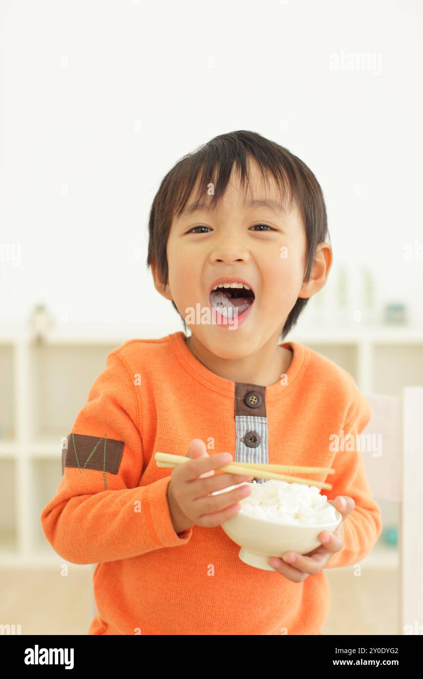 Boy eating rice Stock Photo - Alamy