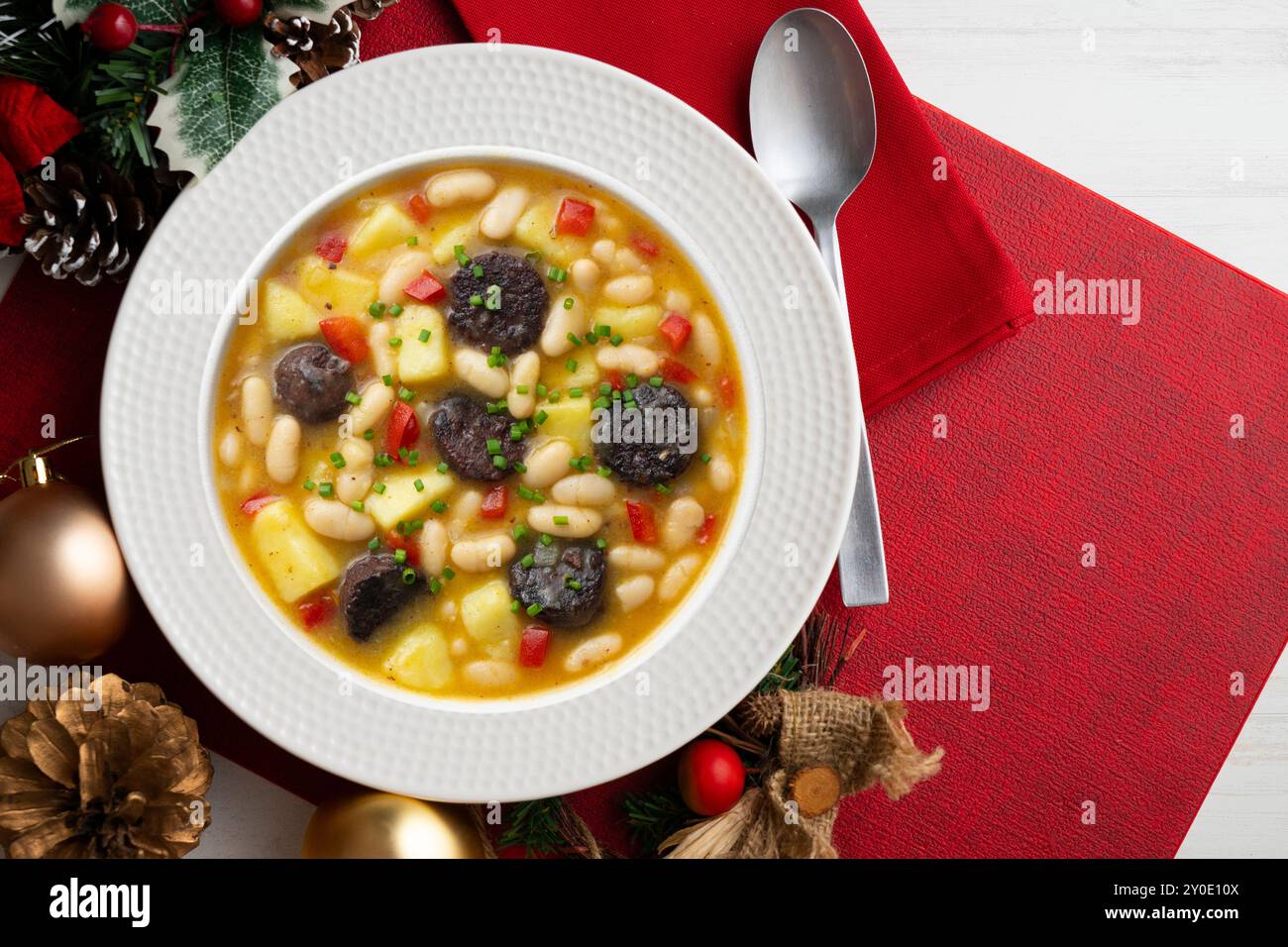 Bean stew with black pudding, peppers and potatoes. Top view table with ...