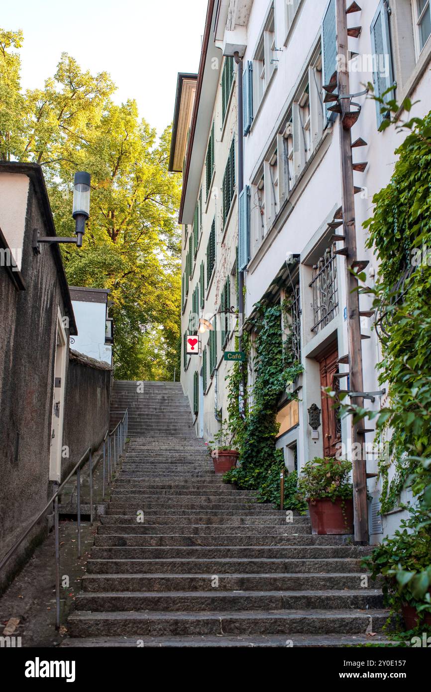 28-08-2024 Zurich, Switzerland. Small shops on narrow street with stone ...