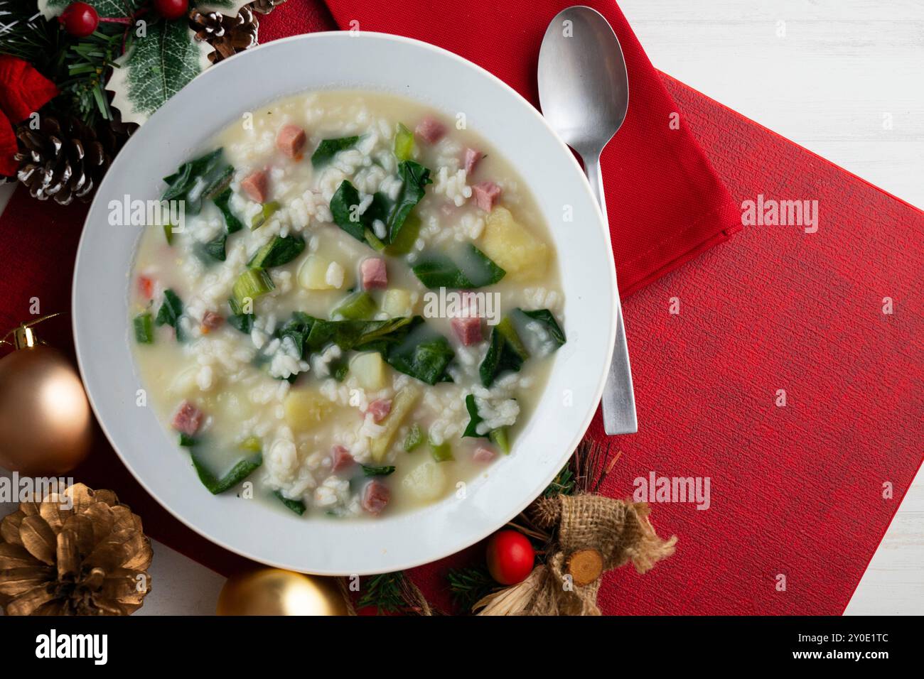 Rice, ham and spinach soup, traditional Spanish tapa. Top view table ...