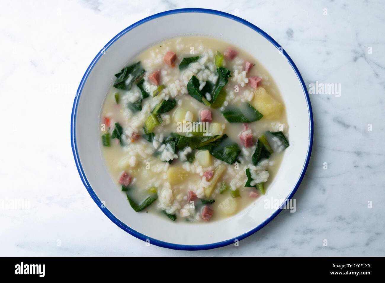 Rice, ham and spinach soup, traditional Spanish tapa. Top view table ...