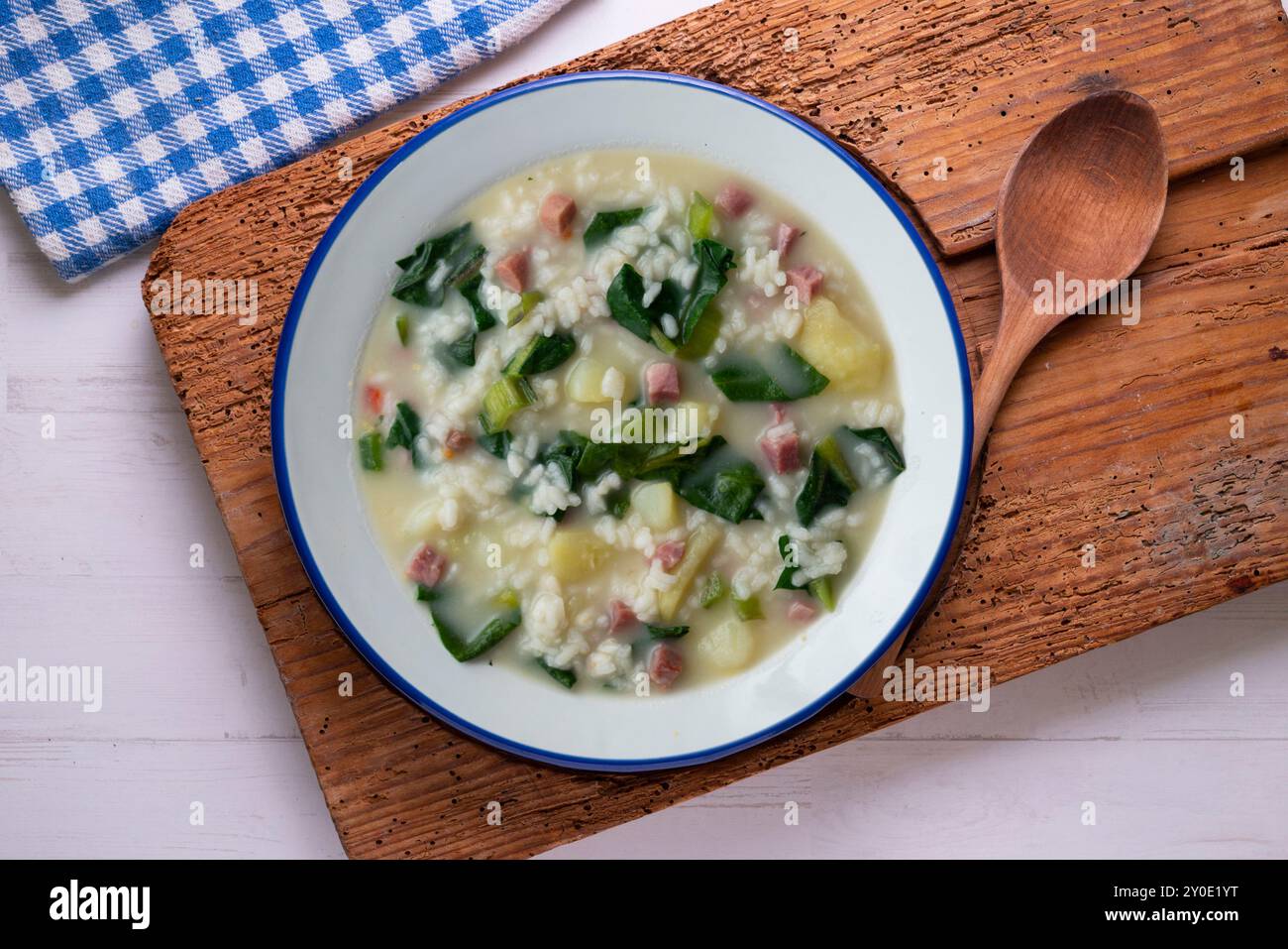 Rice, ham and spinach soup, traditional Spanish tapa. Top view table ...