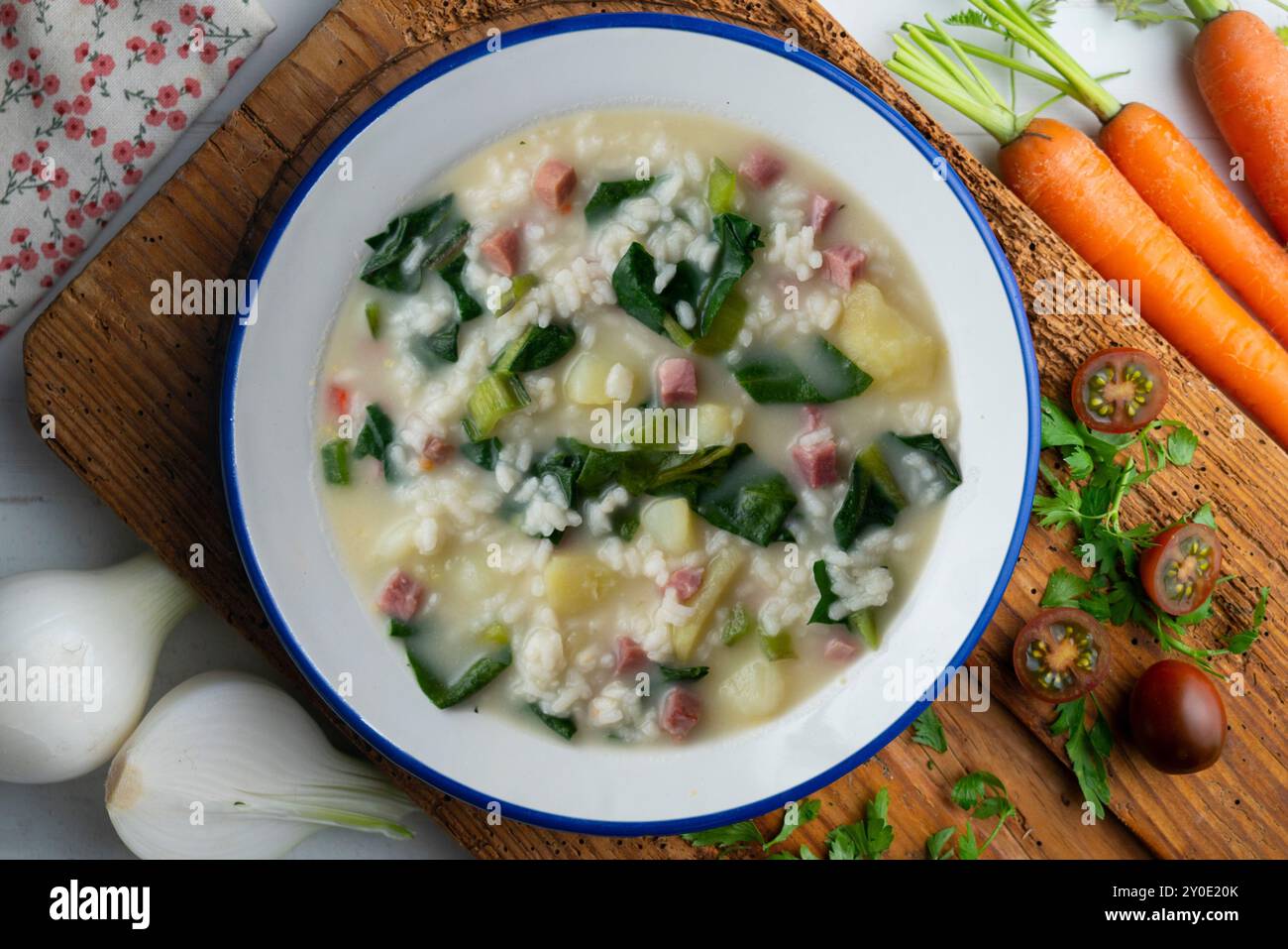 Rice, ham and spinach soup, traditional Spanish tapa. Top view table ...