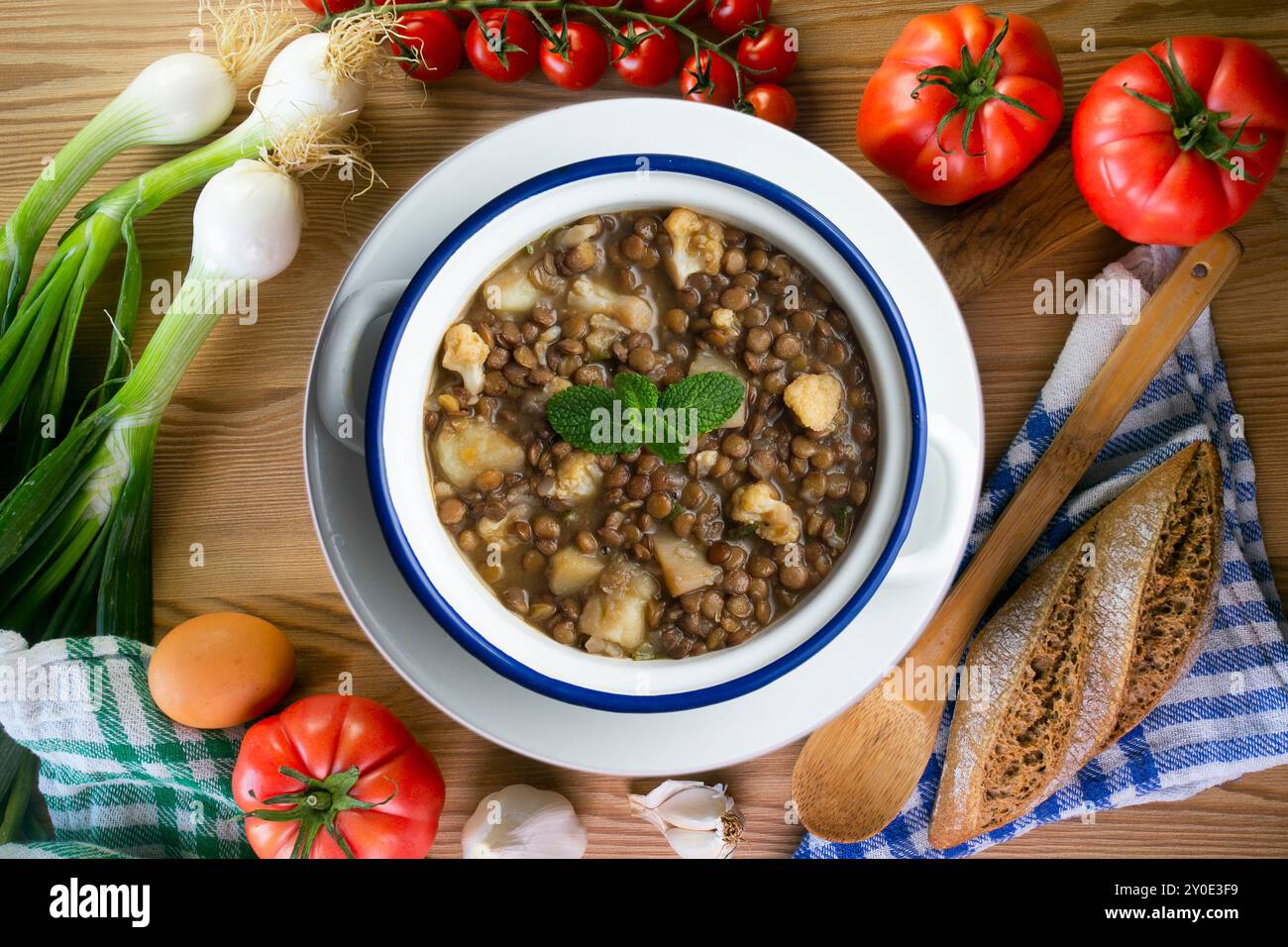 Lentil stew with potatoes, traditional Spanish tapa. Top view table ...