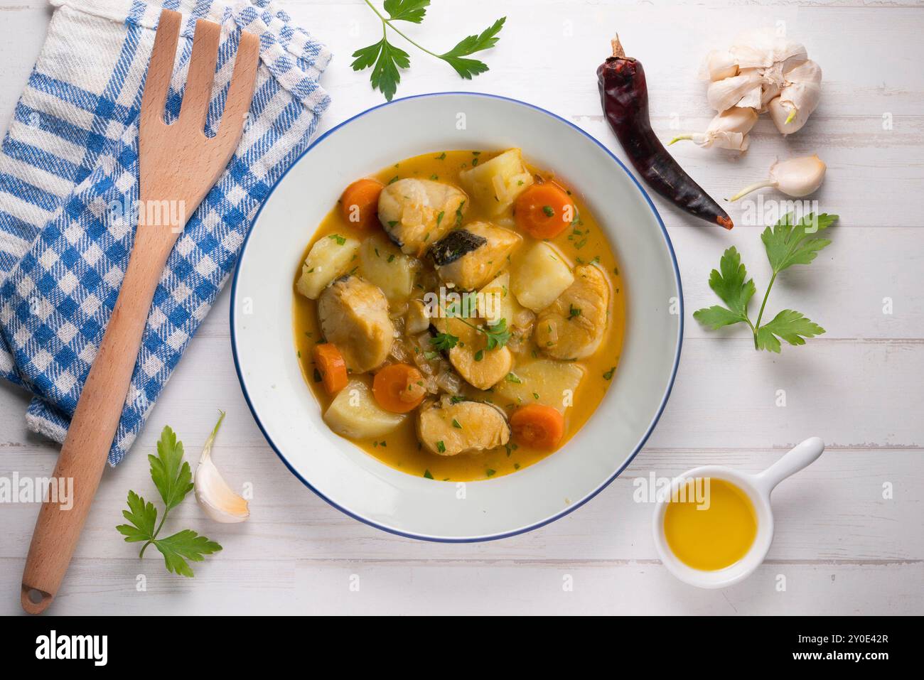 Hake stew with potatoes and carrots. Top view table with decorations ...