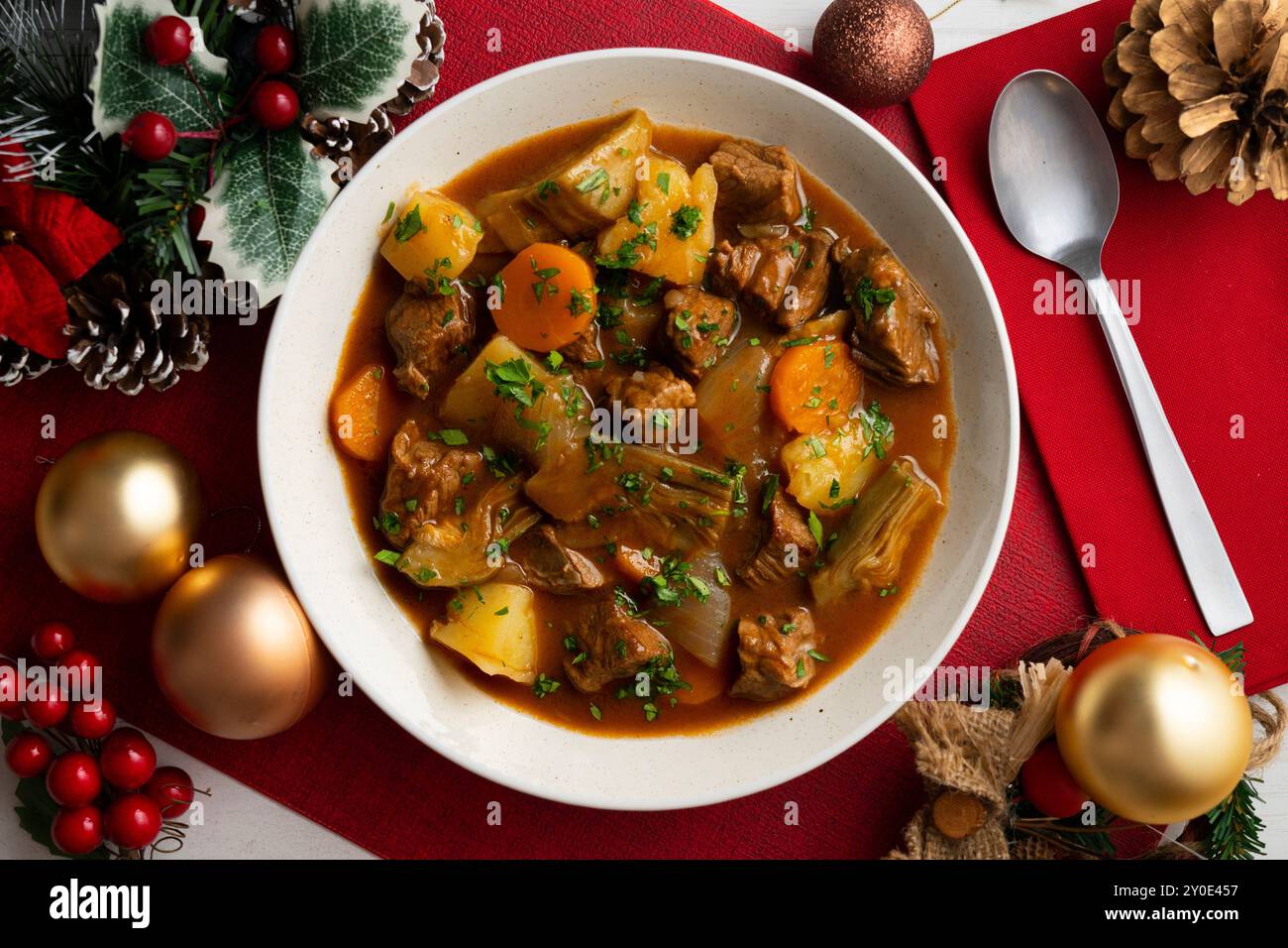 Beef stew with potatoes and artichoke. Top view table with Christmas ...