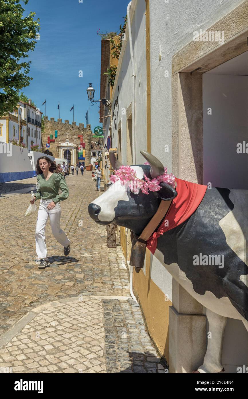 sculpture of a cow in Óbidos, a walled Portuguese town, a tourist ...