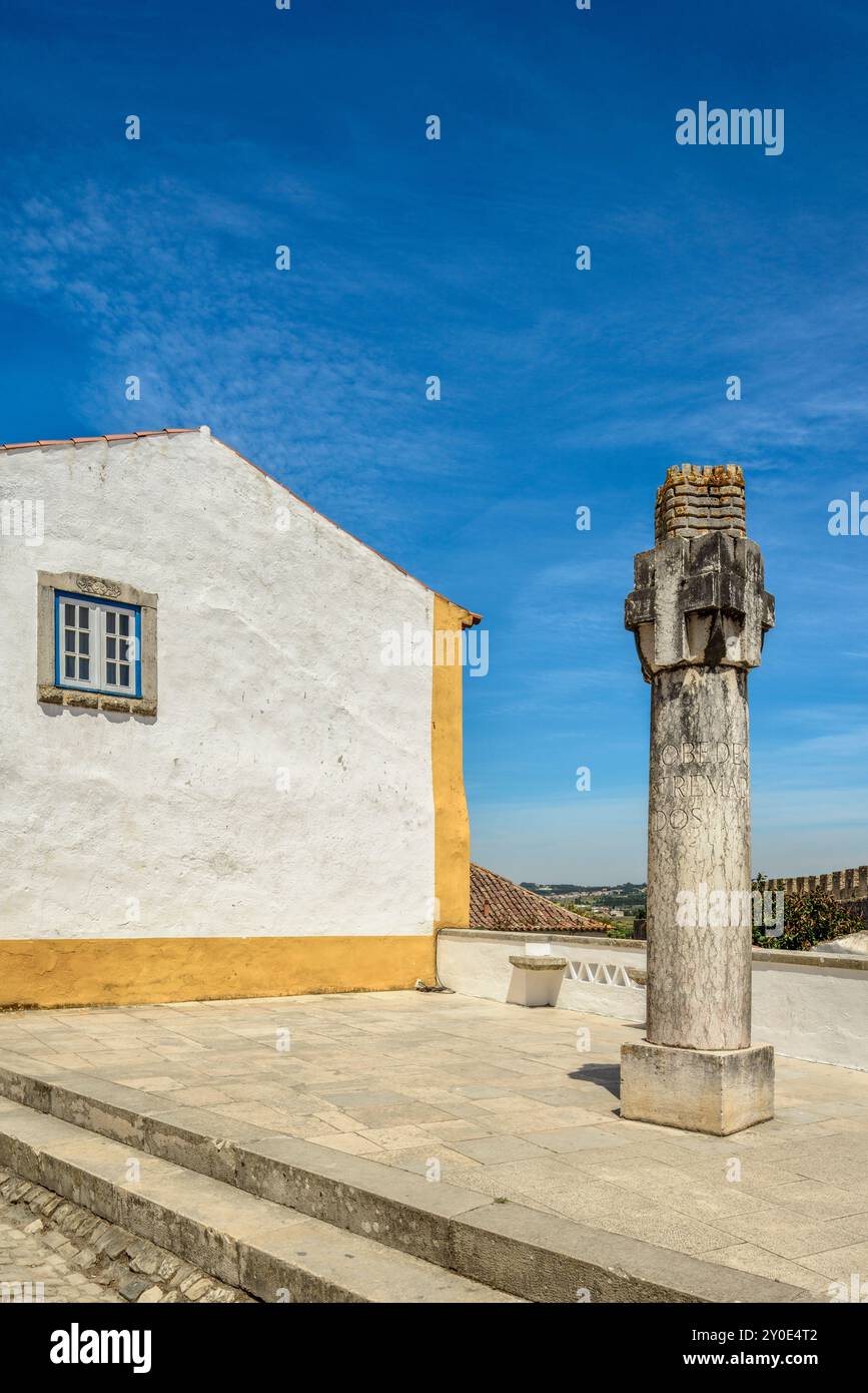 Old stone cross monument.Óbidos, a walled Portuguese town, a tourist ...