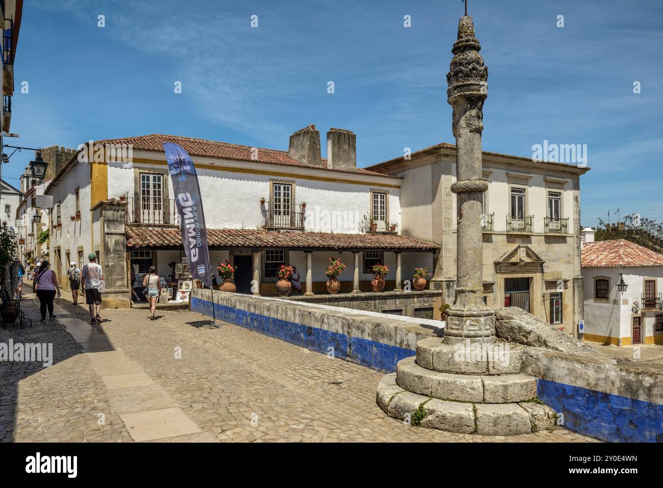Old stone cross monument.Óbidos, a walled Portuguese town, a tourist ...