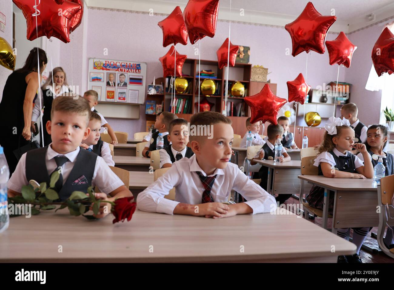 First graders sit in a classroom after a ceremony marking the start of ...