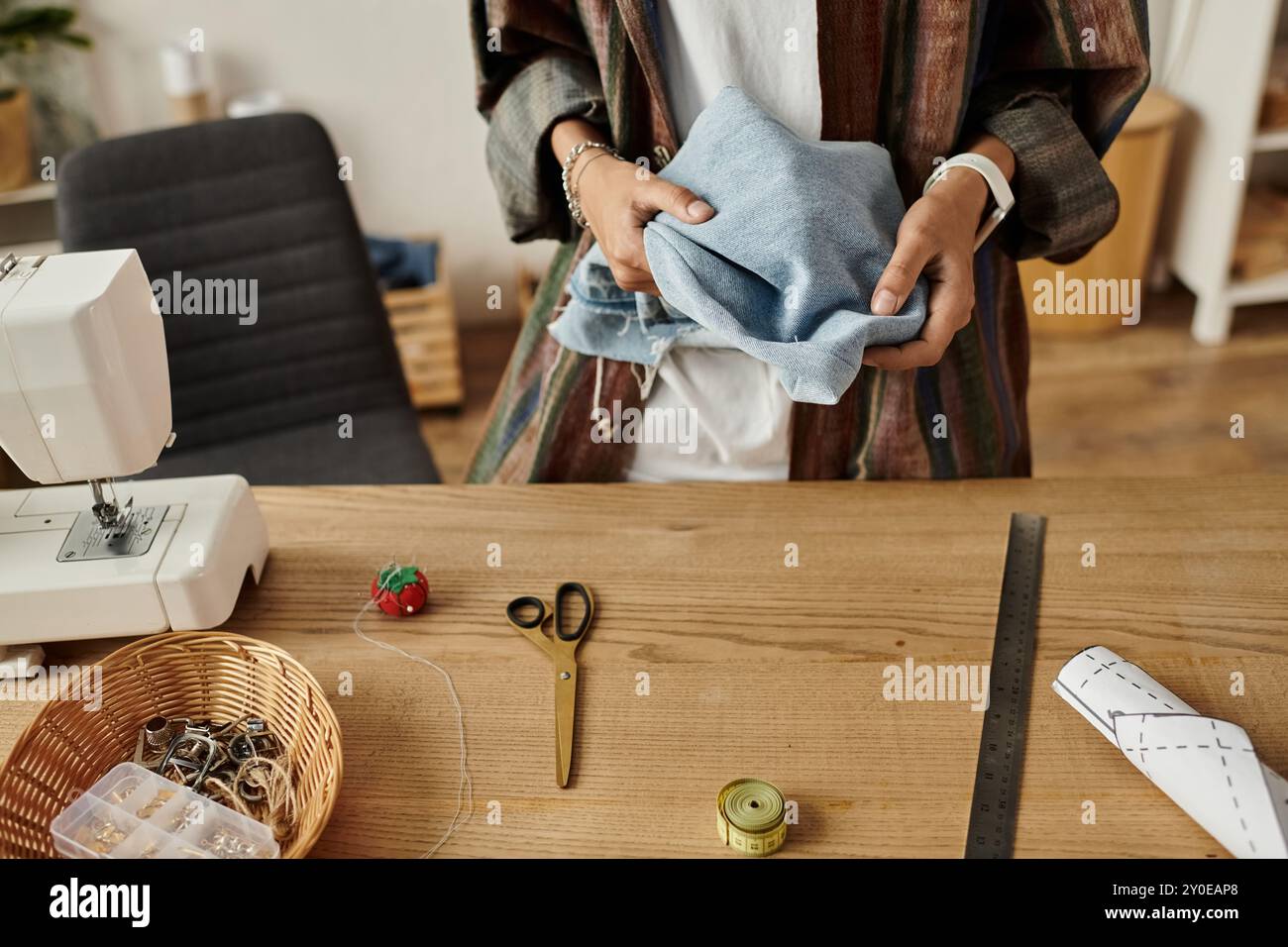 A woman creatively transforms old garments into new fashion Stock Photo ...