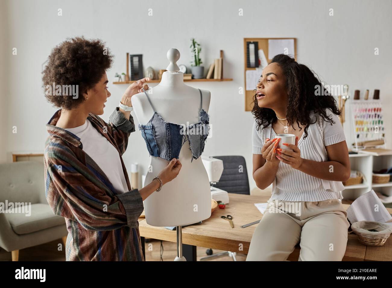 Two people transform garments joyfully in a creative environment Stock ...