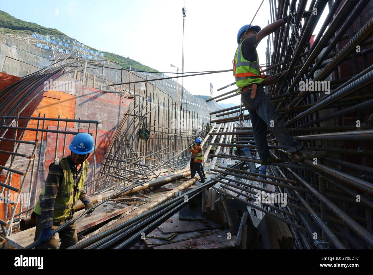 Workers labor at the construction site of Dongzhuang Water Conservancy ...