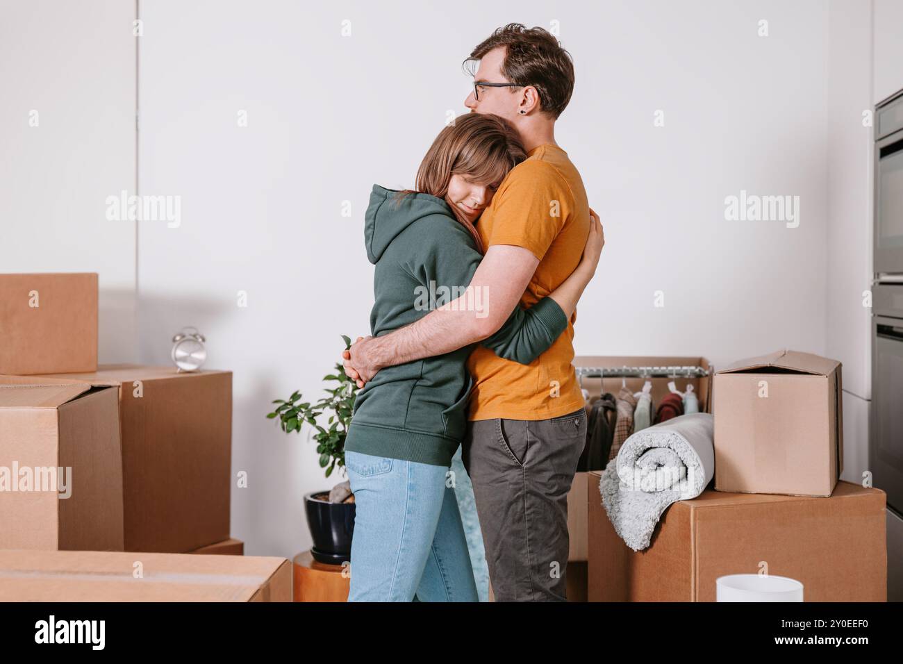 Man warm hugs woman with love in new home, moving unpacked boxes ...