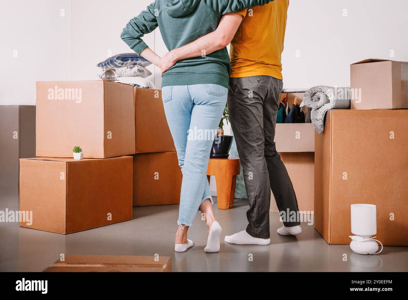 Couple is standing and hugging from the back view, looking at moving ...