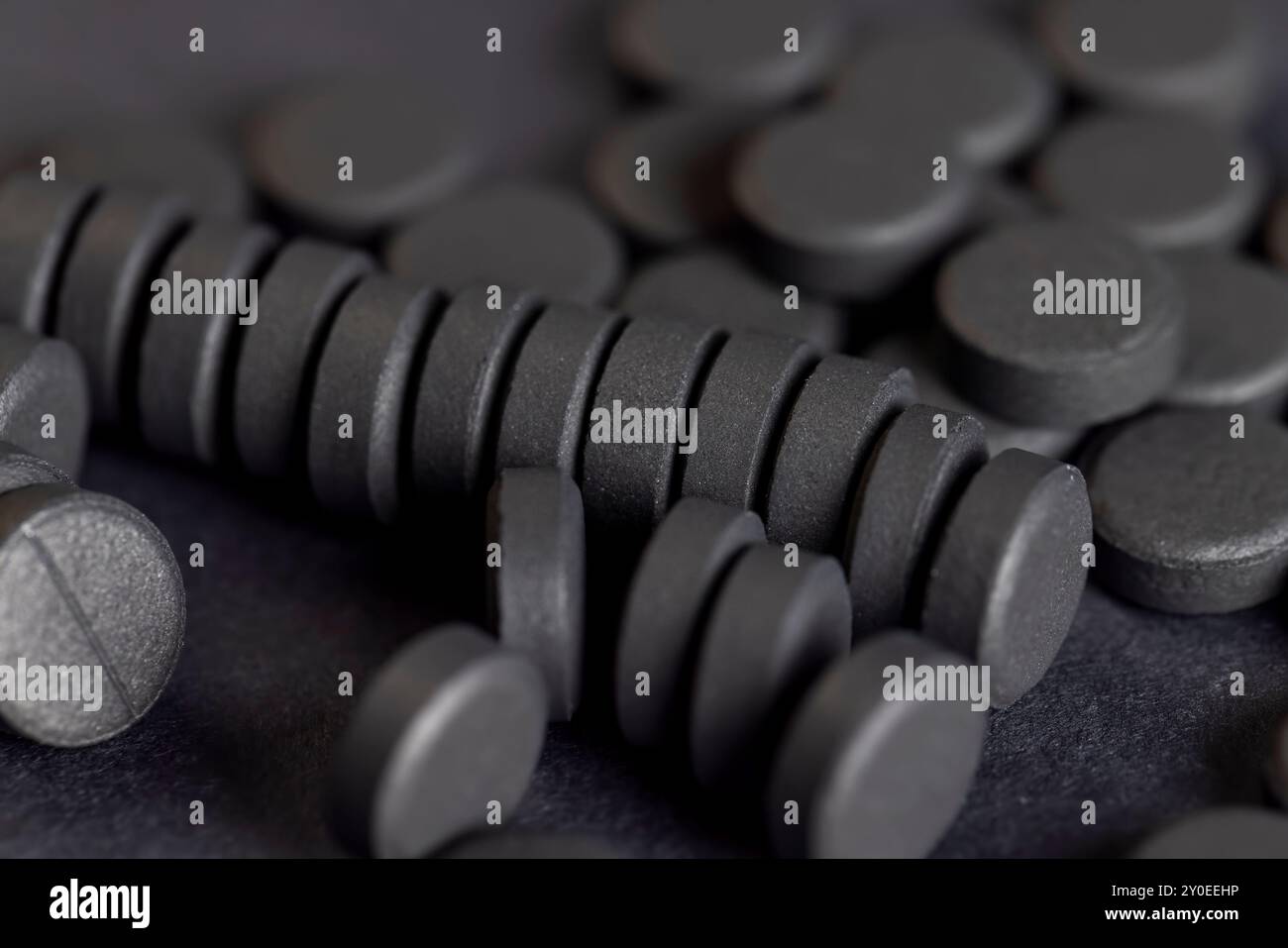 Open and unpacked tablets of black color close-up, a large number of ...